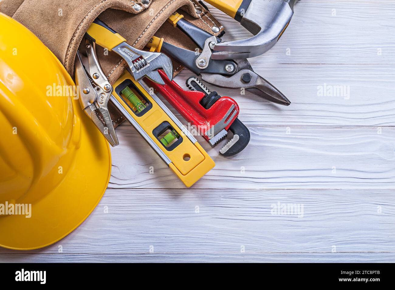 Leather tool belt safety building helmet on wood board construction ...