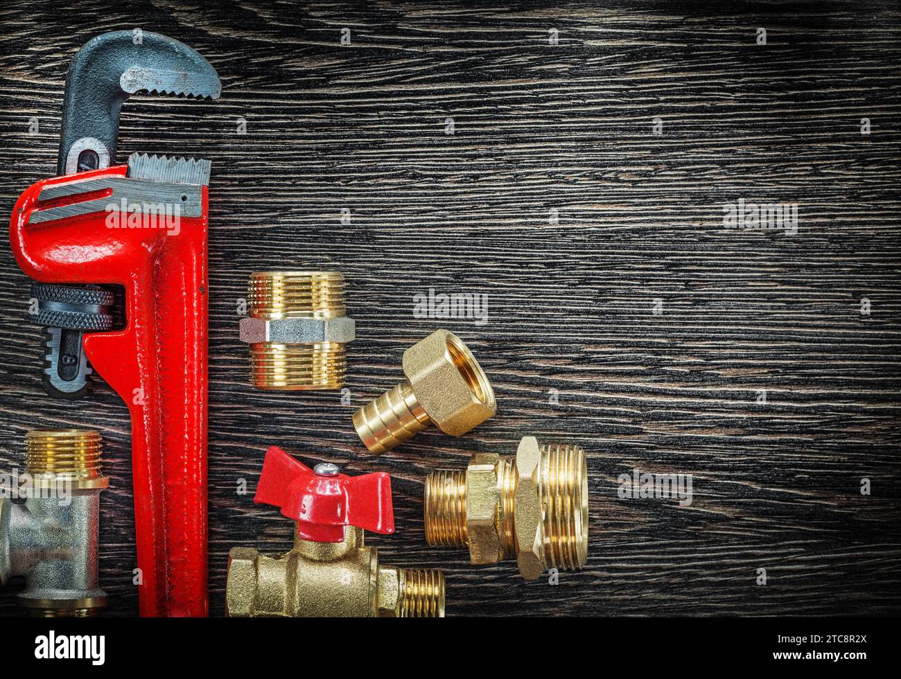 Plumbing adjustable wrench threaded pipe fittings water valve on wooden ...
