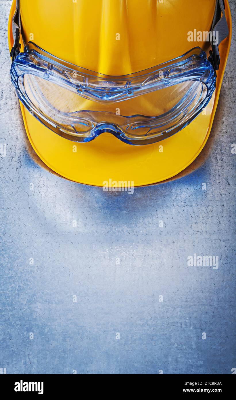 Plastic goggles building helmet on metallic background construction ...