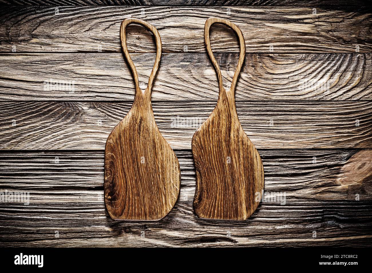 Two small serving boards with large handles in close-up on old wood ...