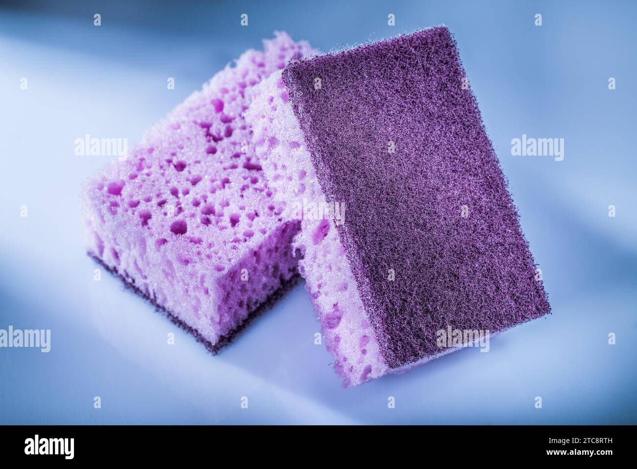 New purple kitchen sponges on a white background Stock Photo - Alamy