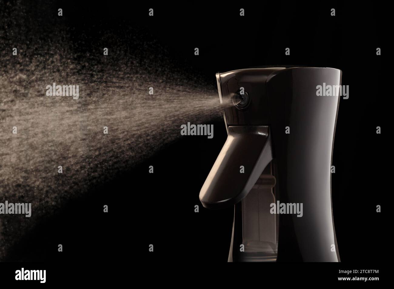 Close up of a spray gun on black background. Spraying water ...