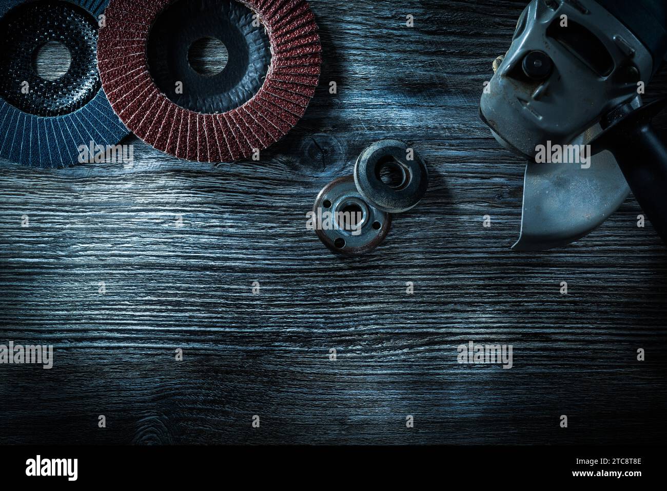 Angle grinder with rotating sanding discs on an old wooden board Stock ...