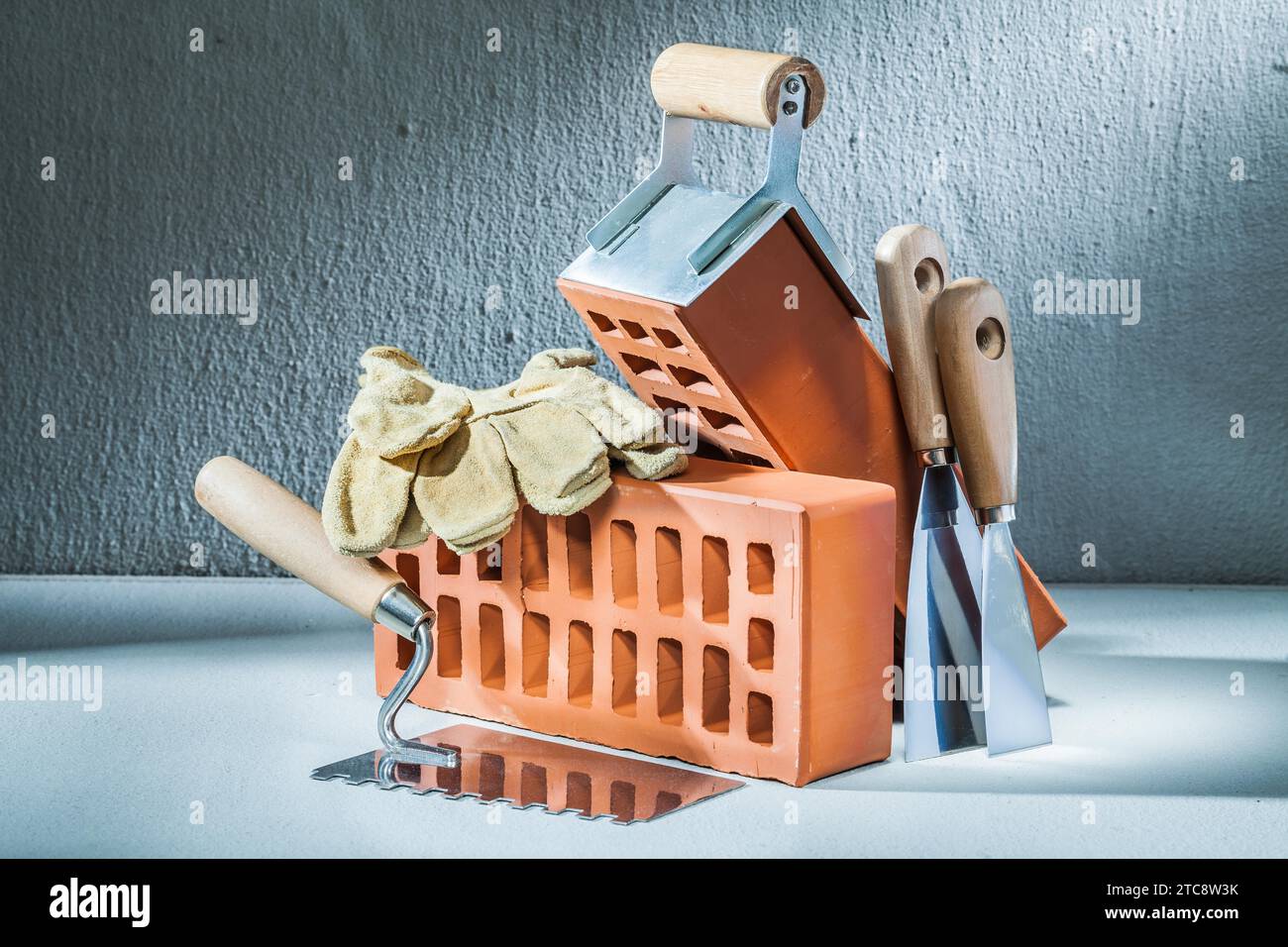 Brick gloves and plastering tools on concrete Stock Photo - Alamy