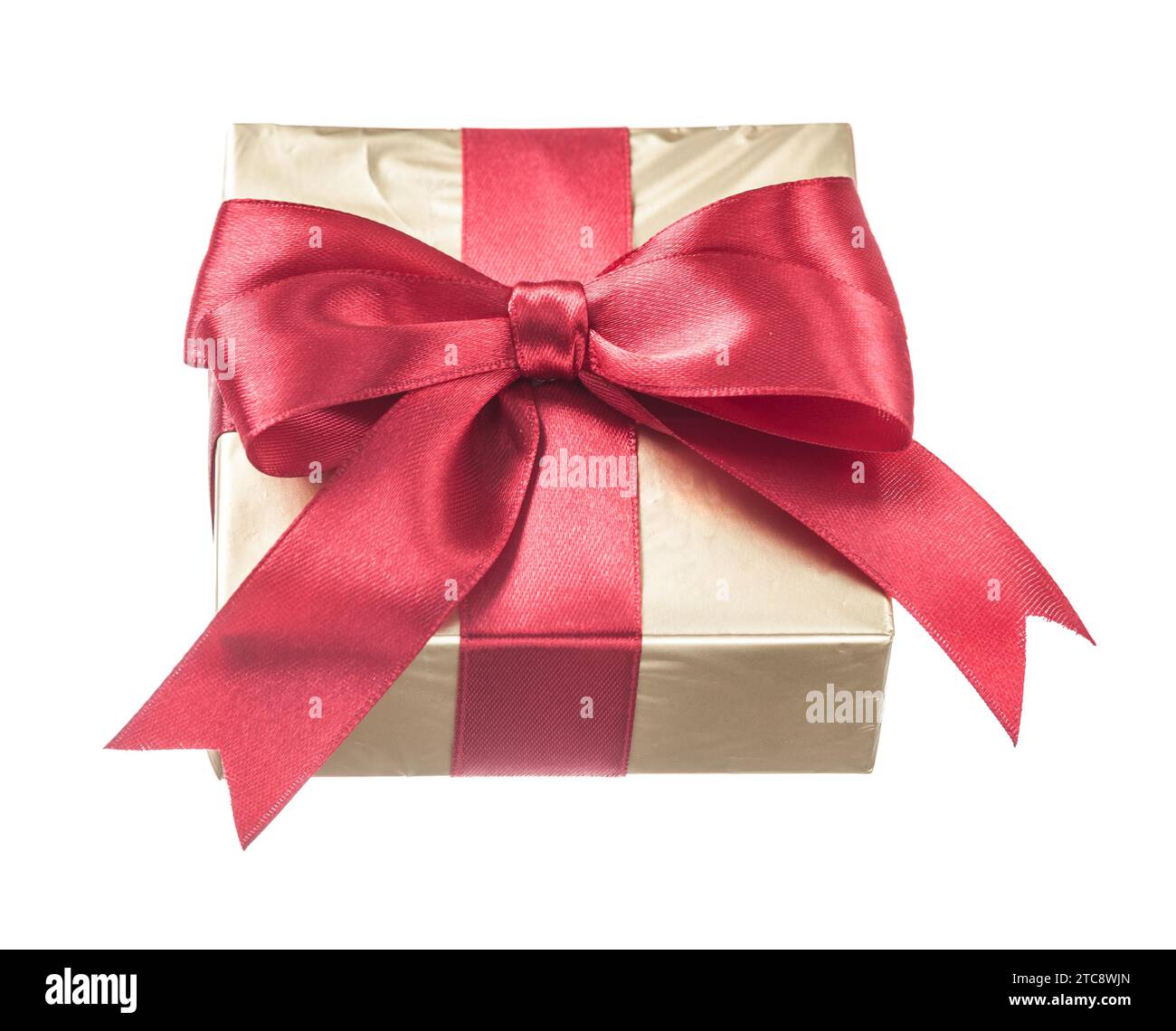 Gift wrapped in glitter paper with a red bow against a white background ...