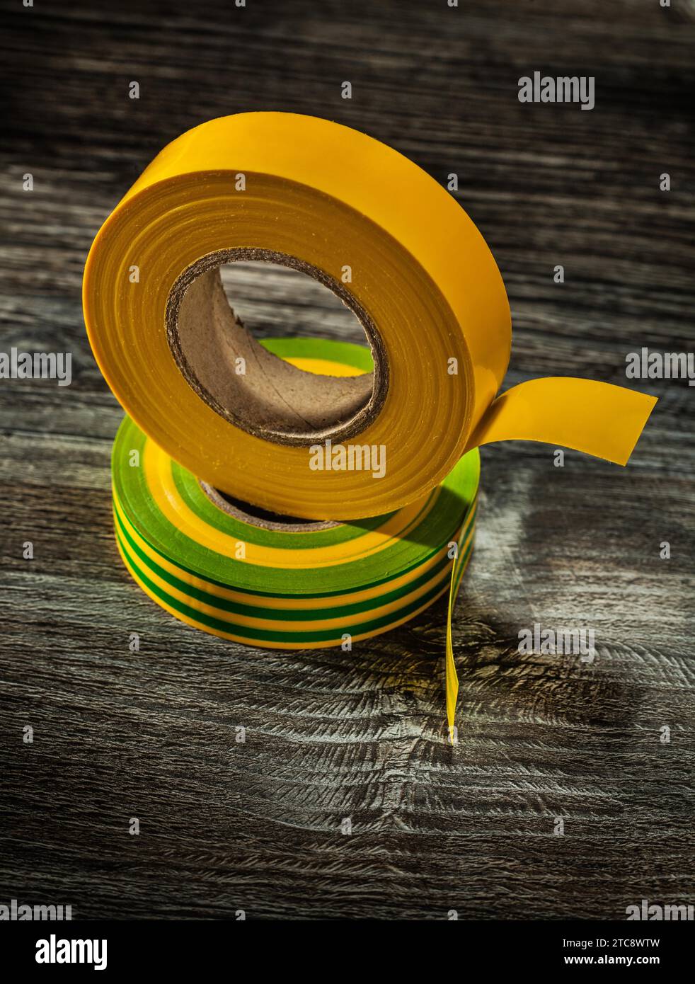 Insulating tapes on wooden panel Vertical view Stock Photo - Alamy
