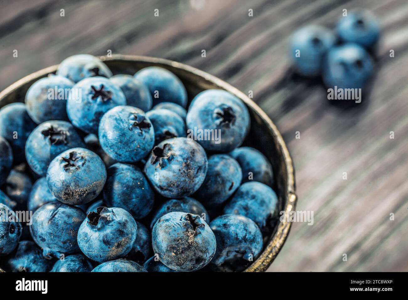 A bunch of blueberries in an old metal bowl Stock Photo - Alamy