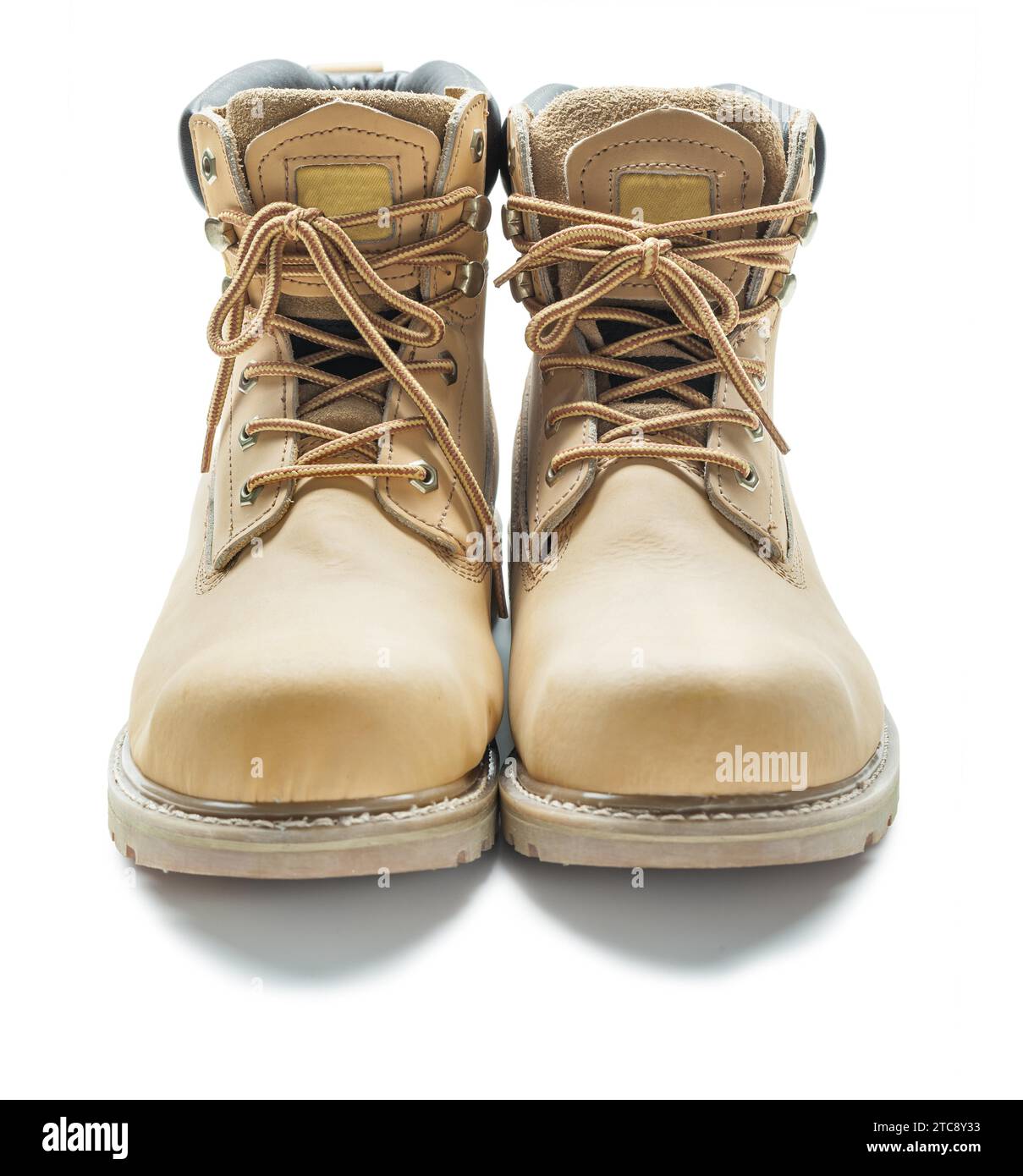 Leather work boots against a white background Stock Photo - Alamy