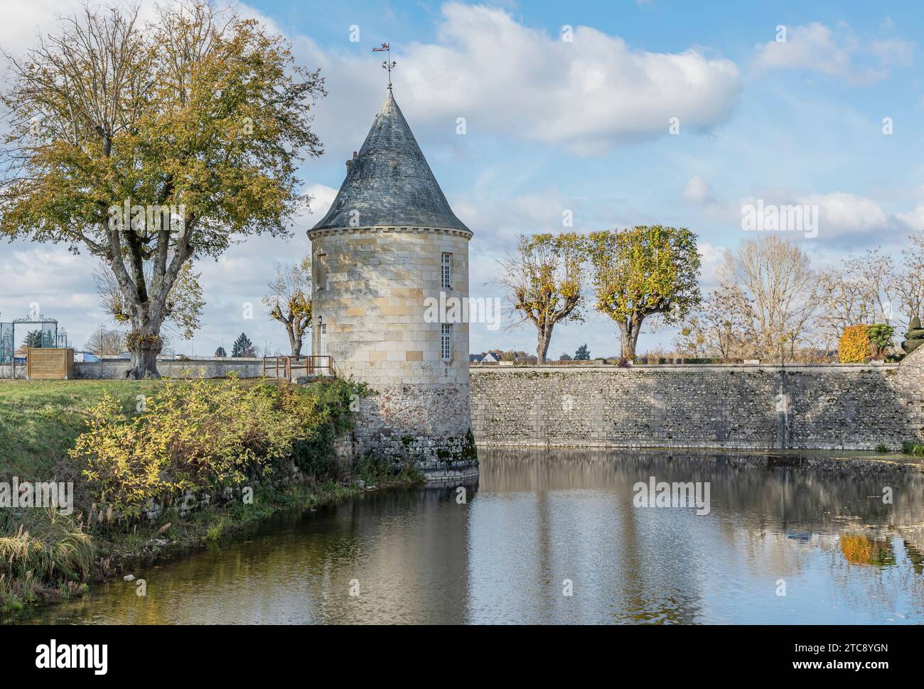 Ornate round tower on the corner of a castle moat at the castle ...