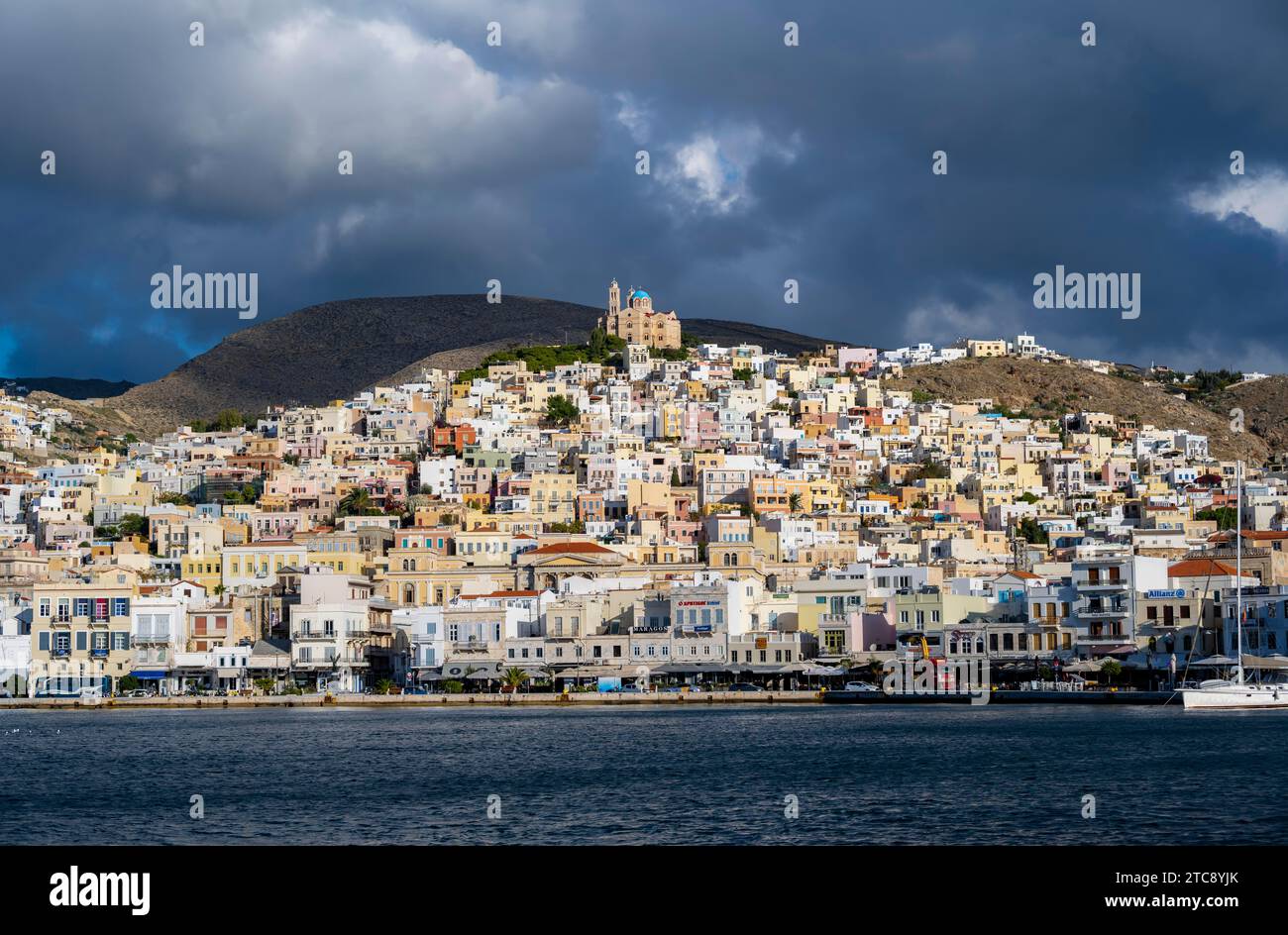 View of the town of Ermoupoli with pastel-coloured houses and the sea ...