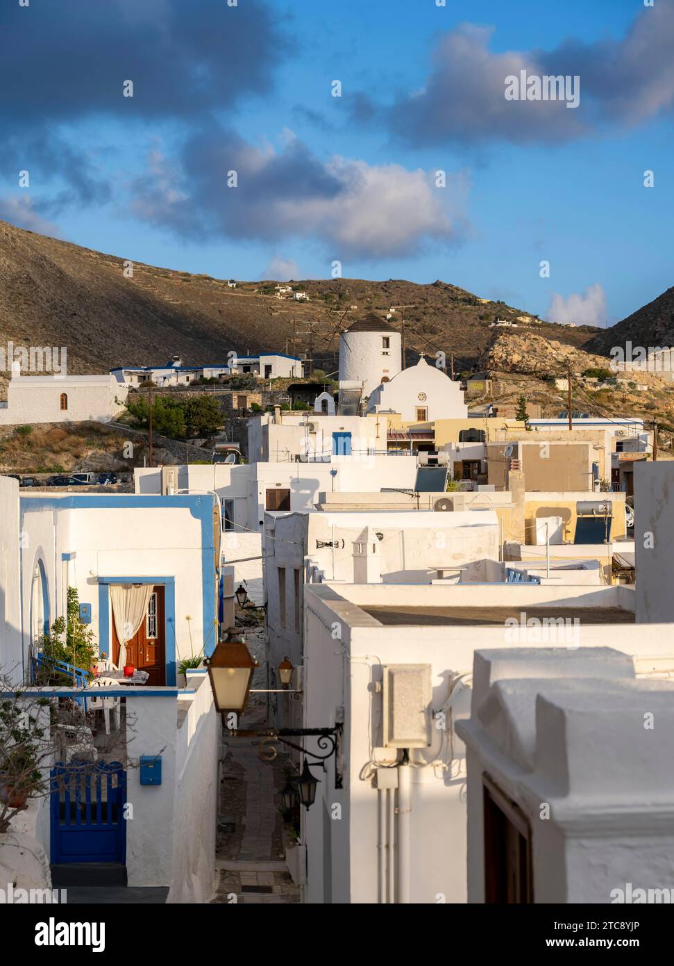 Alleys with white Cycladic houses in Ano Syros, windmill and mountains ...