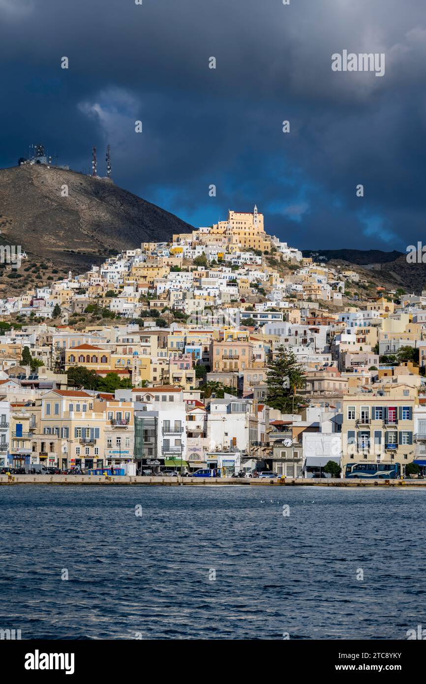 View of the town of Ermoupoli with pastel-coloured houses and sea, on ...