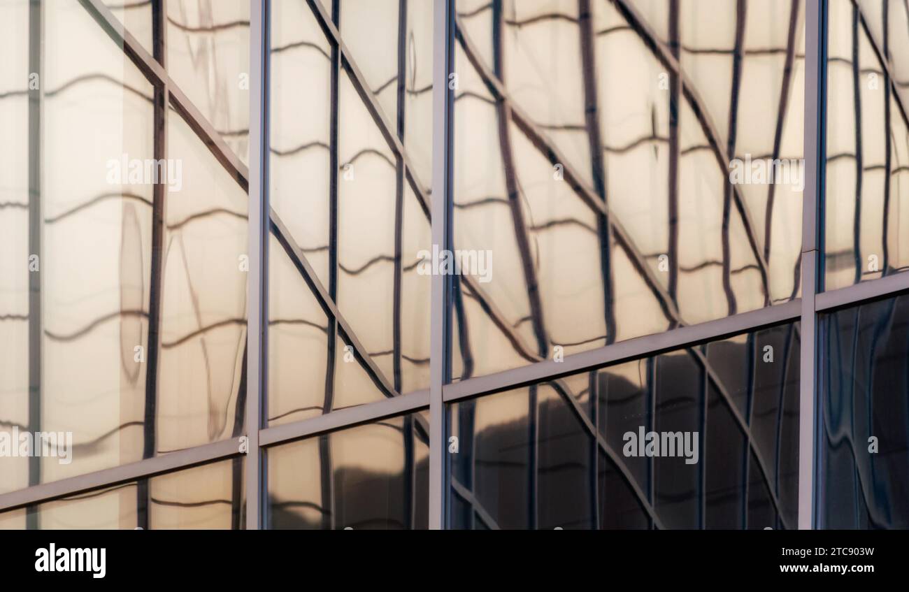 Reflection with distortion in the window of a modern building color ...