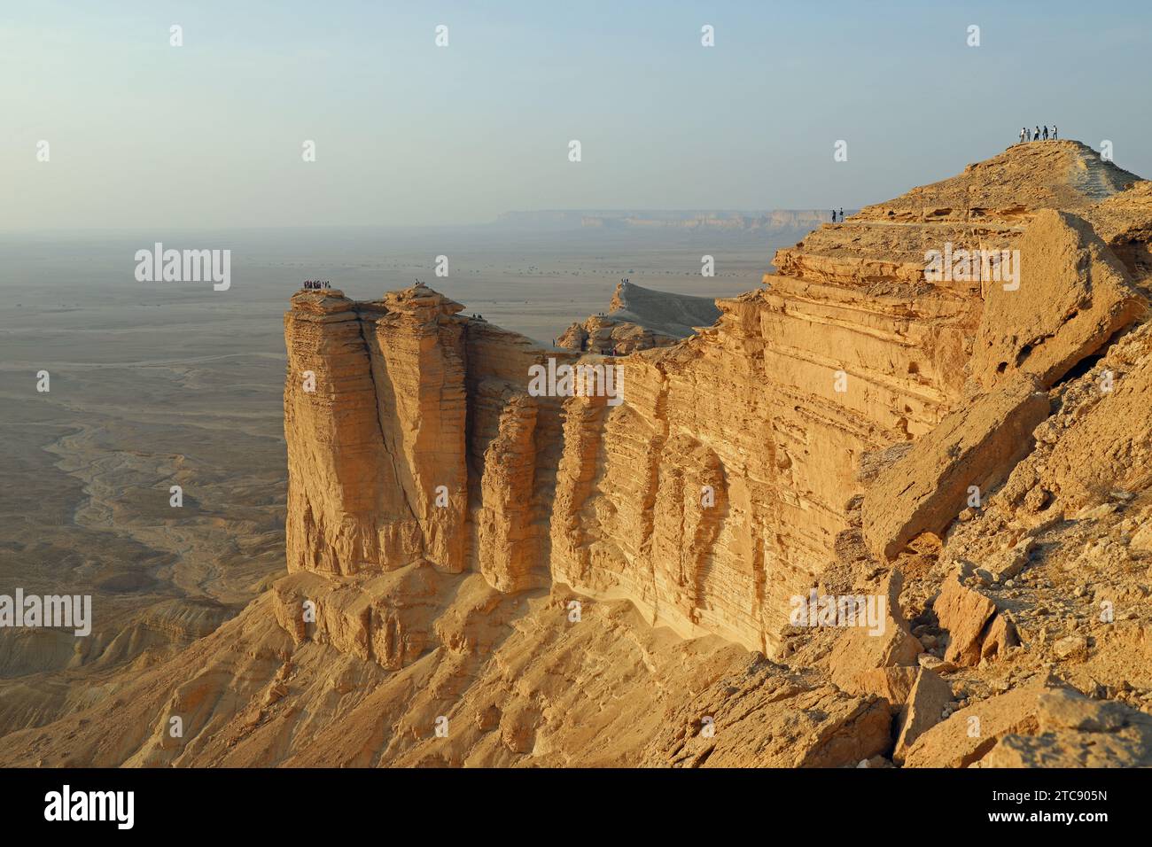 Tourists on the dramatic cliffs at the Edge of the World in Saudi ...