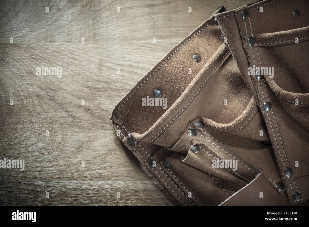 Leather construction belt on wooden board Stock Photo - Alamy