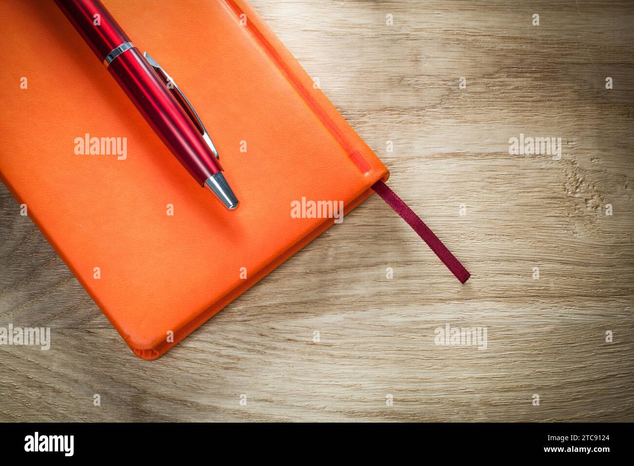 Orange-coloured notebook biros Top view Stock Photo - Alamy