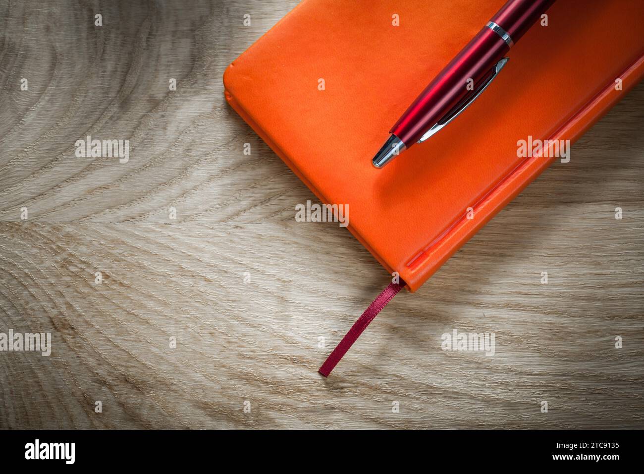 Orange-coloured notebook biros Top view Stock Photo - Alamy