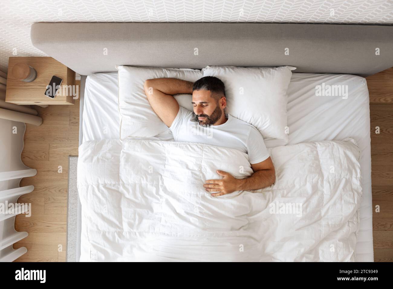 Top view of sleeping guy enjoying restful nap in bedroom Stock Photo ...