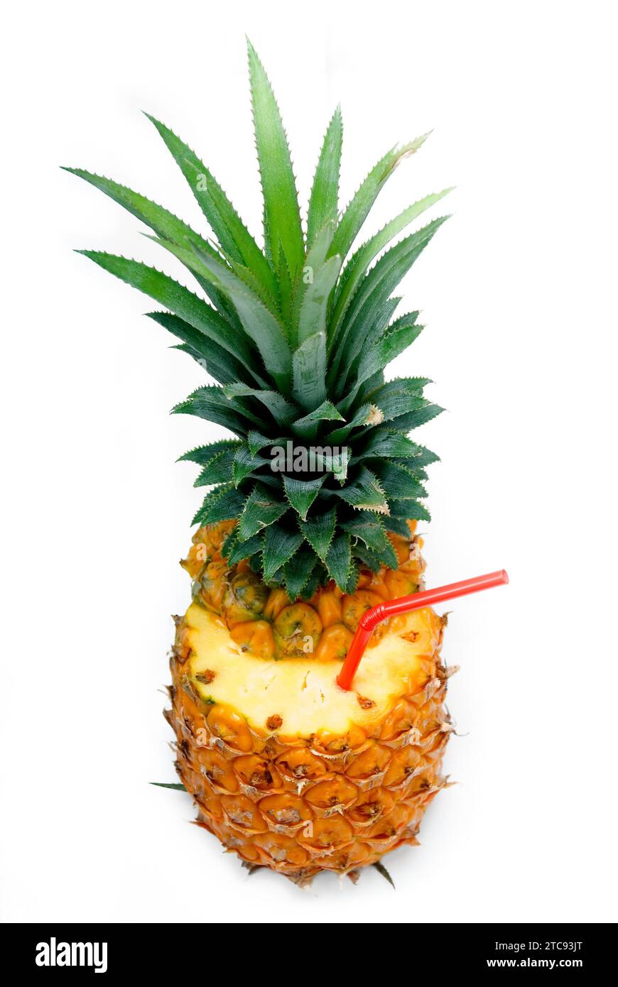 ripe pineapple cutted on top with red and blue straws isolated on white ...