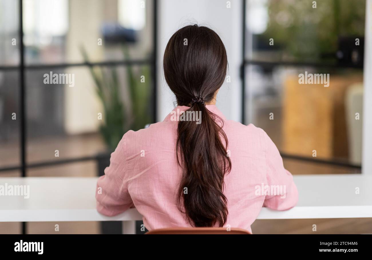 Millennial arab businesswoman hr manager at empty desk in modern ...