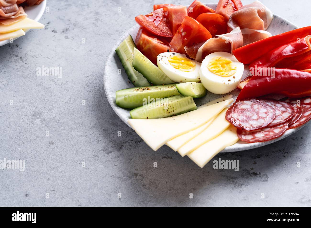 Healthy snack plate with cheese, meat, vegetables, boiled egg ...