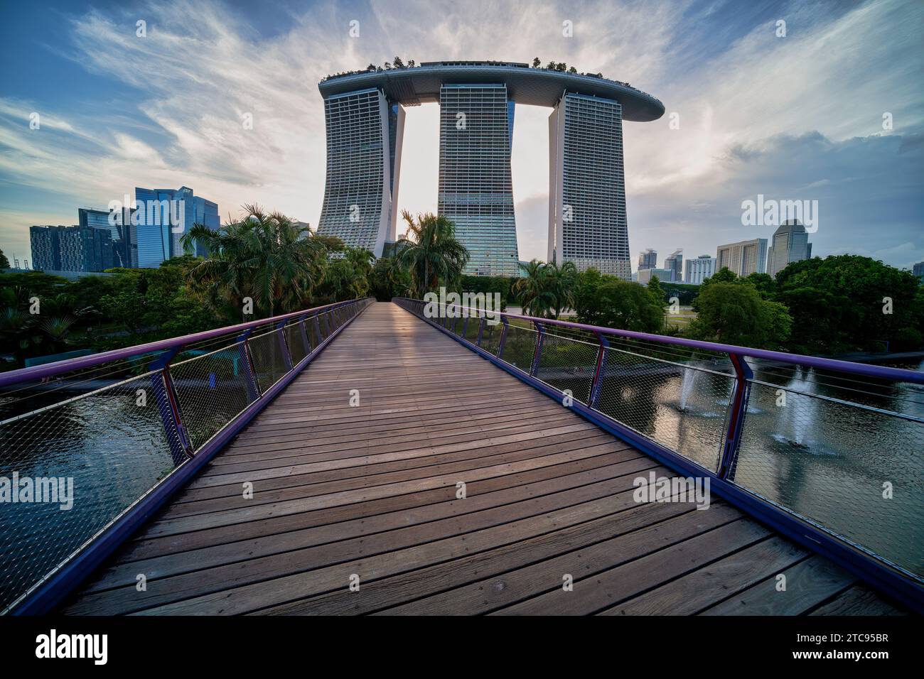 The Marina Bay Sands hotel with a wooden dock in the foreground ...