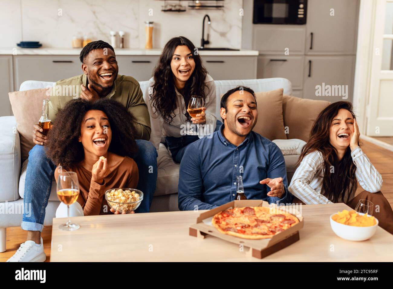 Diverse young students eating pizza hi-res stock photography and images ...