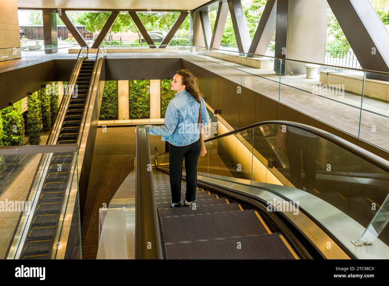 Teenage Girl Riding an Escalator in Downtown San Francisco Modern ...