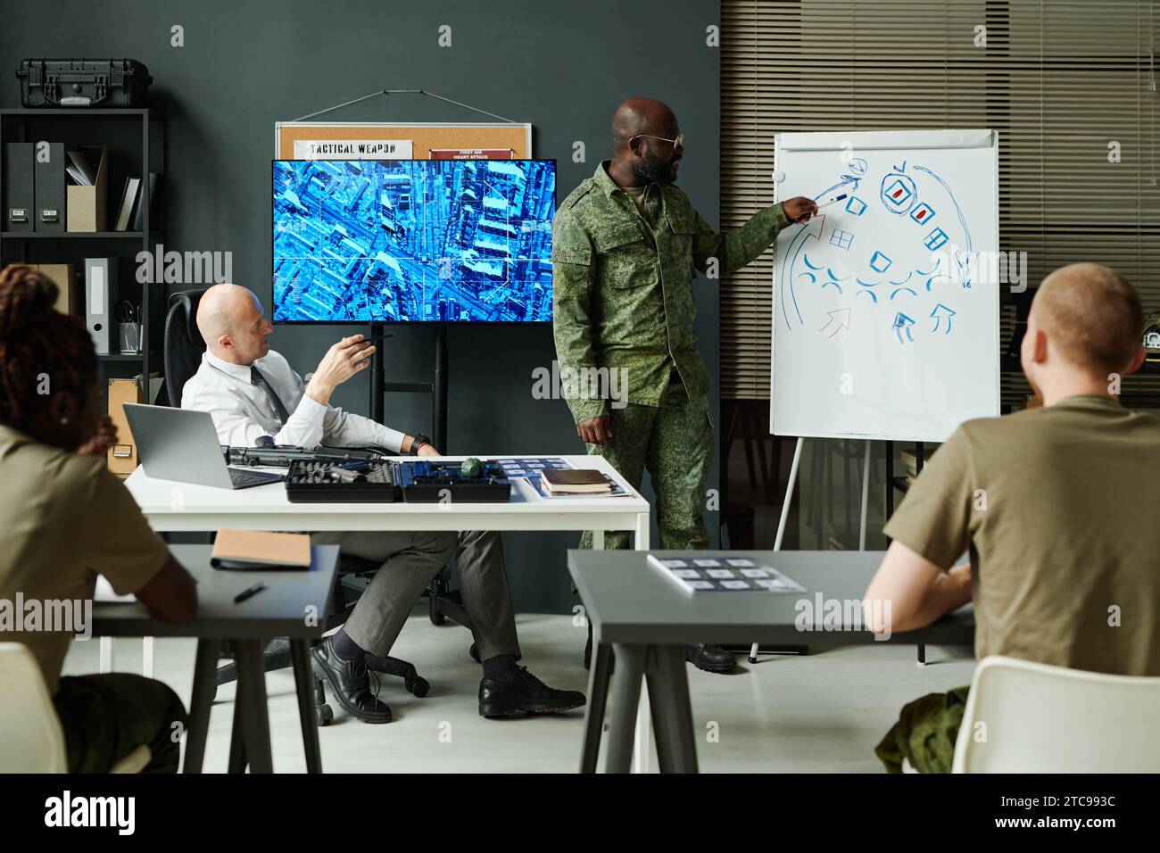 Young African American soldier in camouflage uniform pointing at ...