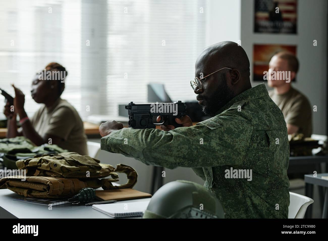 African American guy in camouflage uniform shooting from gun during ...