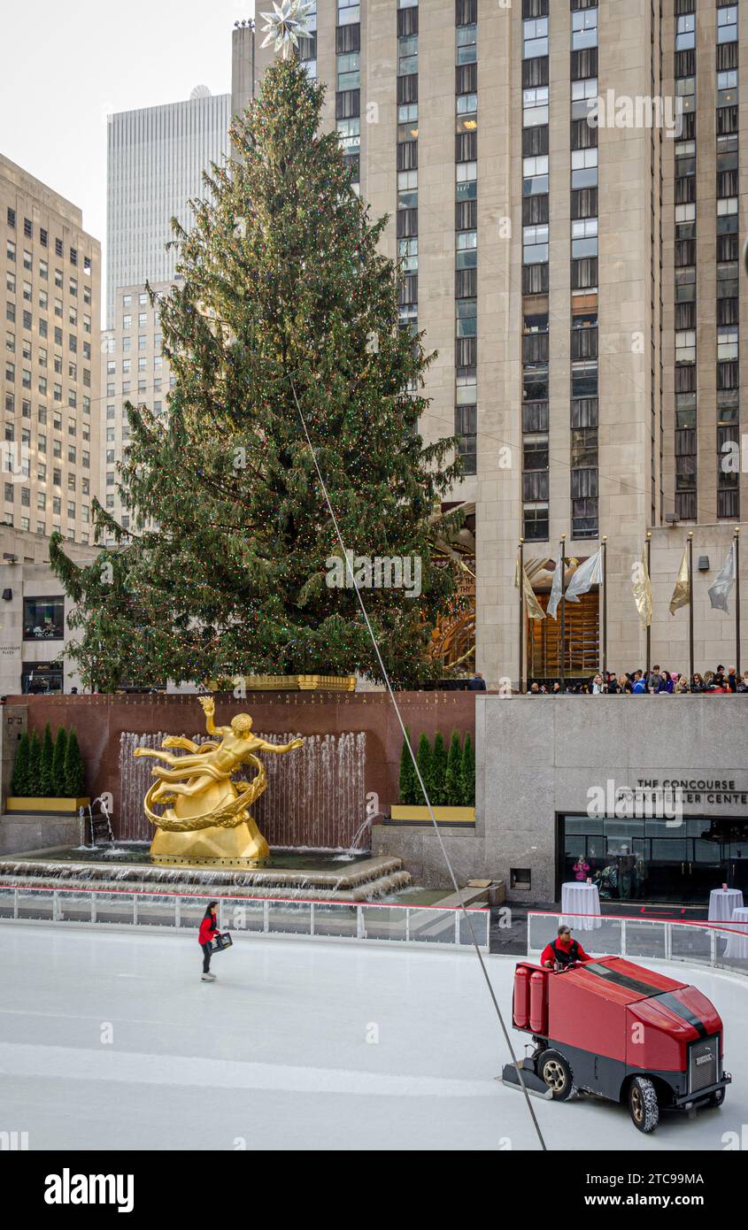A lone ice skater with the Zamboni clearing the ice at Rockafeller ...