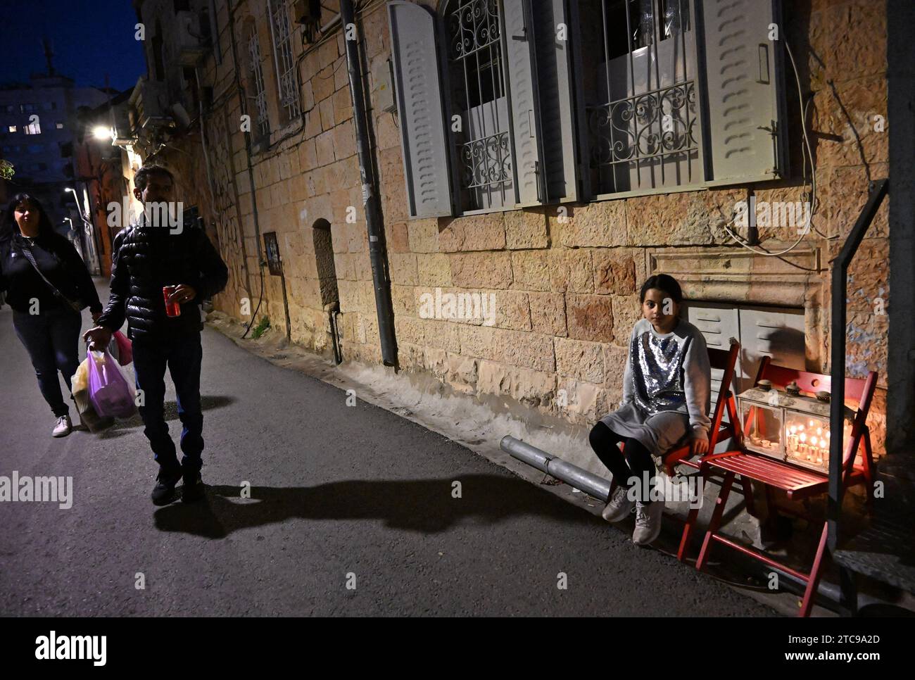 Jerusalem, Israel. 11th Dec, 2023. An Israeli girl sits beside a ...