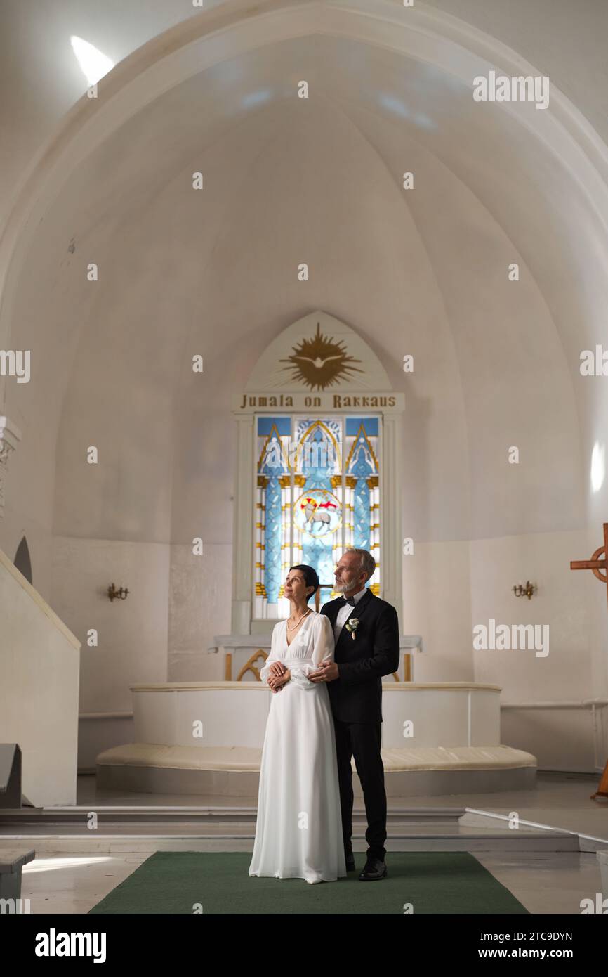 Ethereal wide angle portrait of elegant senior couple as bride and ...