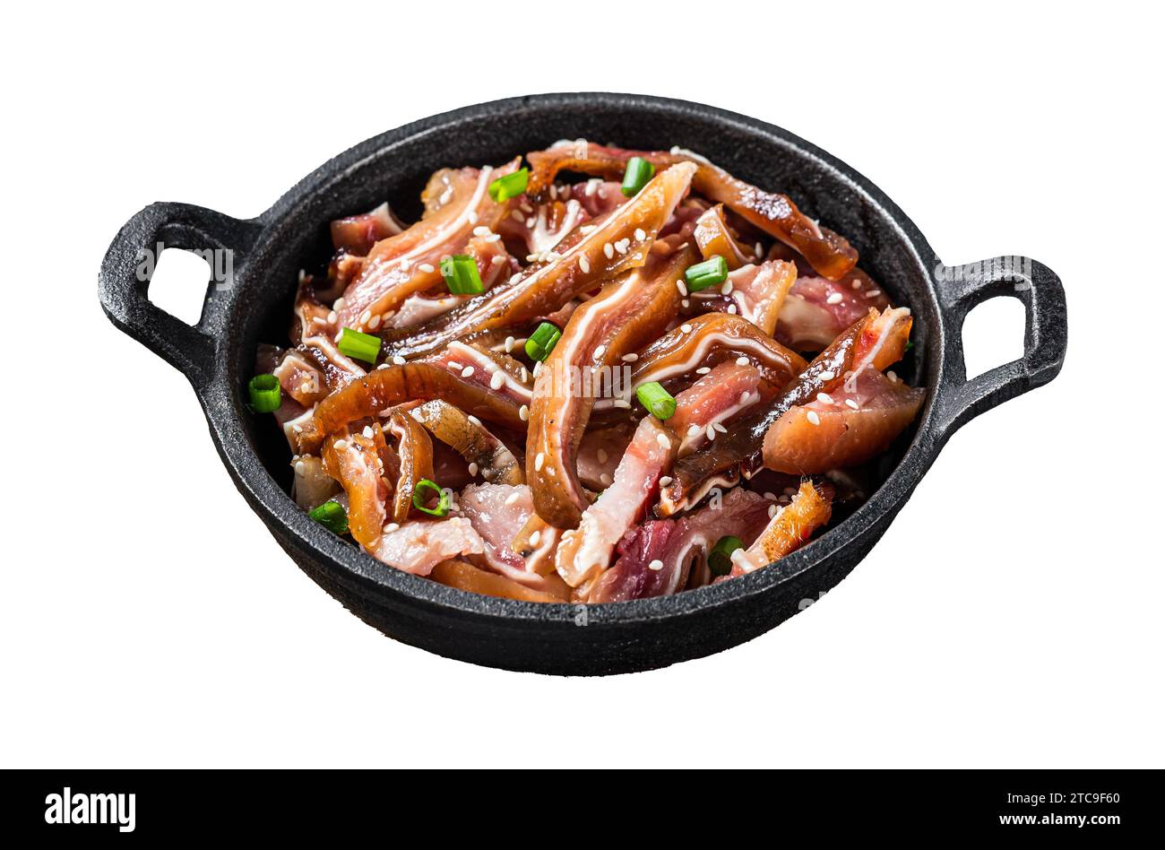 Fried spicy pork pig ears served in a frying pan. Isolated, white ...