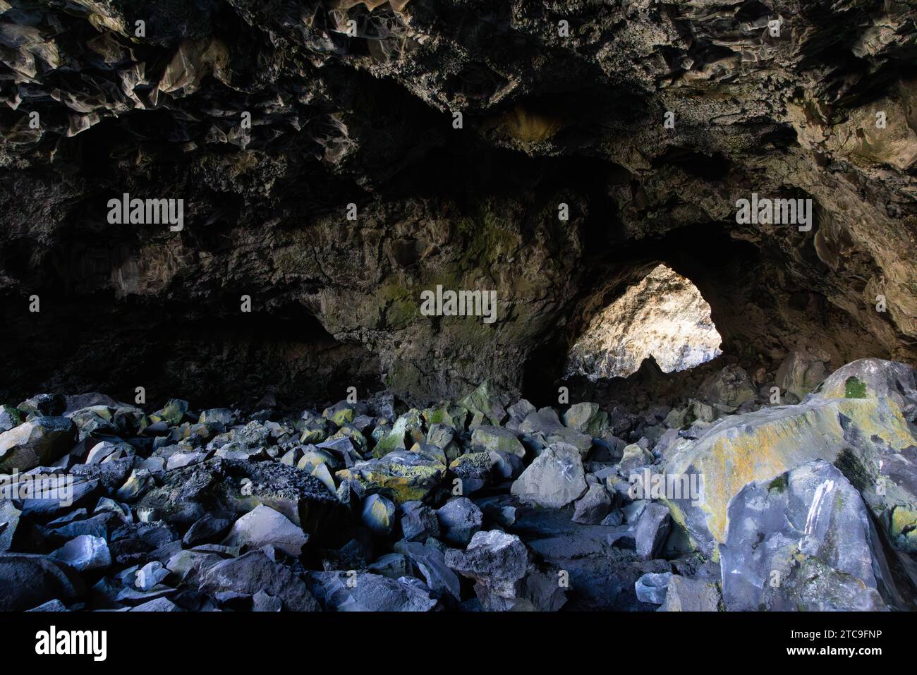 A cave opening beyond a large rock fall in Indian Tunnel. Craters of ...