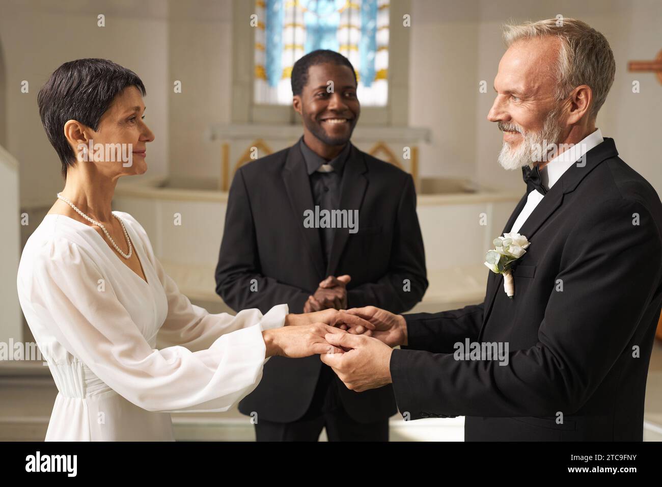 Side view portrait of loving senior couple getting married at church ...
