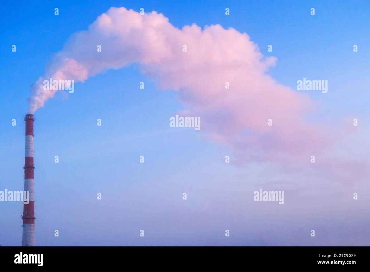 Smoking pipes making clouds against sunset sky background. Dioxide air ...
