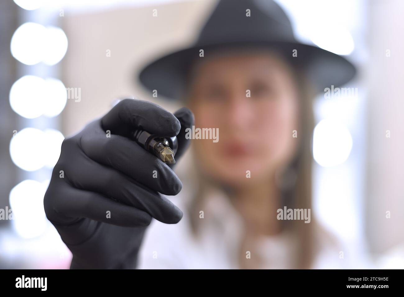 Woman master of art of tattooing posing in workshop studio. Art and ...