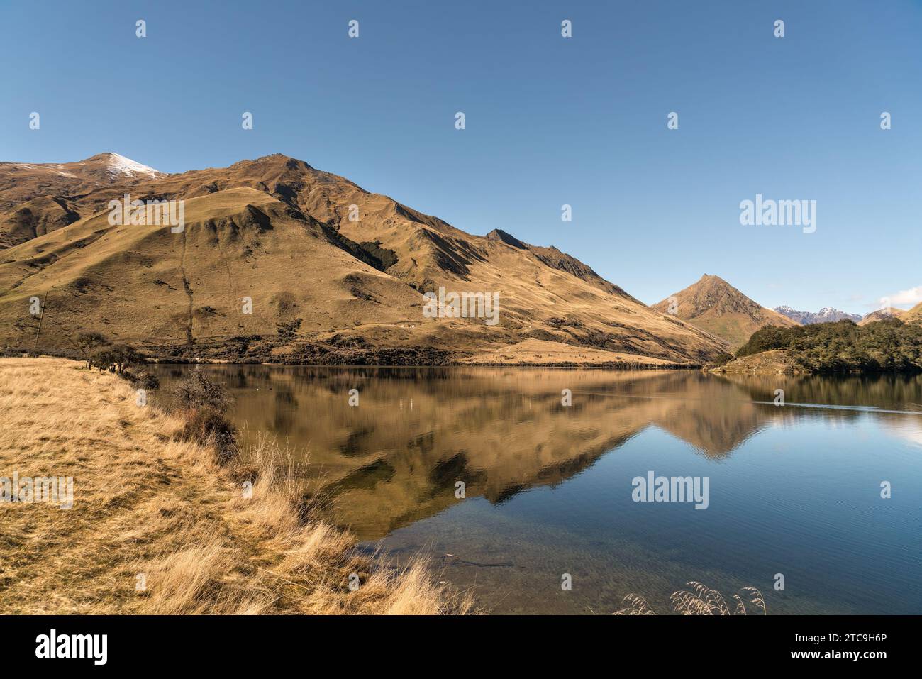 Crystal clear reflection on the very still water moke lake in the ...