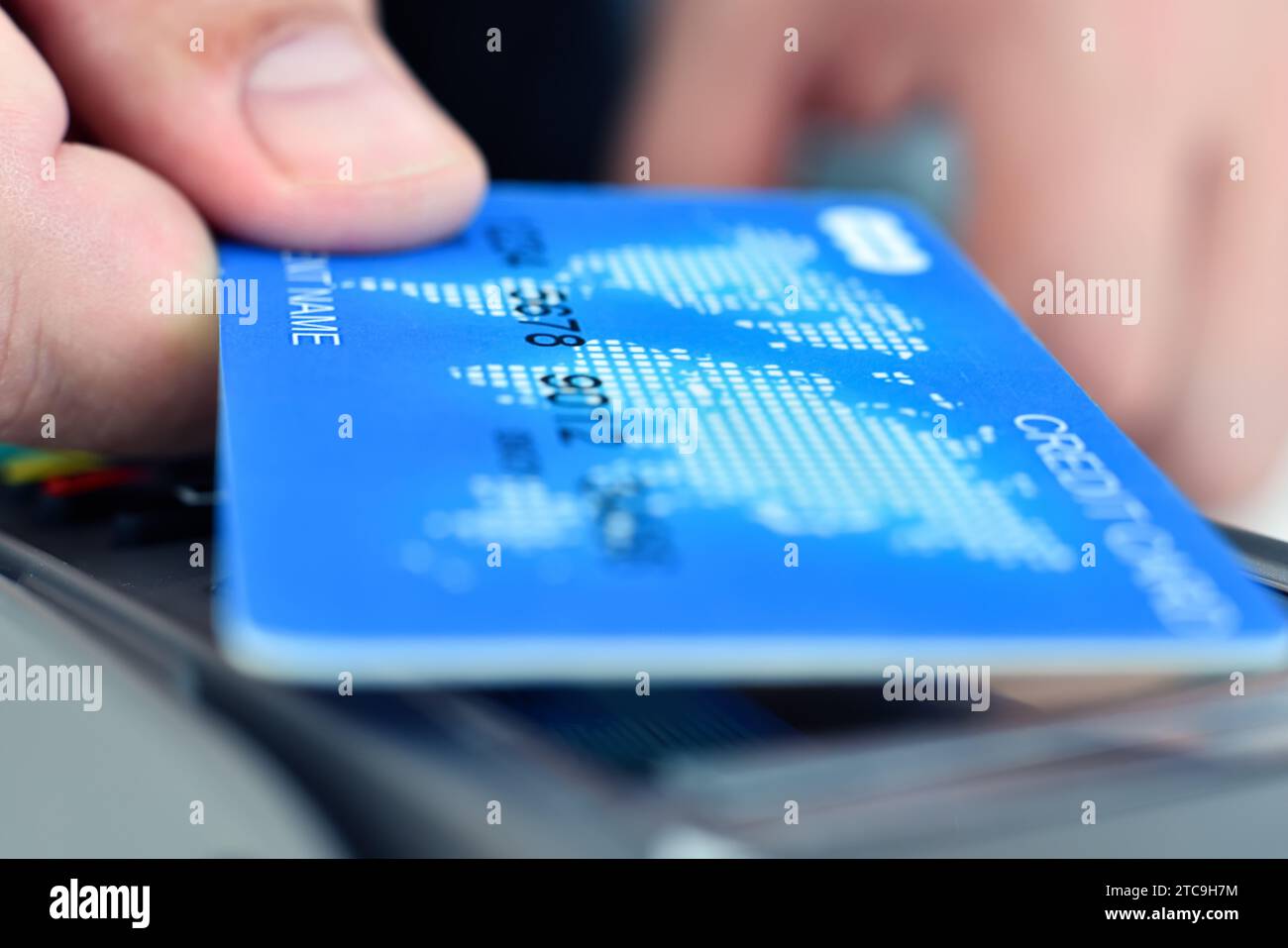 Hand using blue credit card with nfc techology. Electronic money and ...