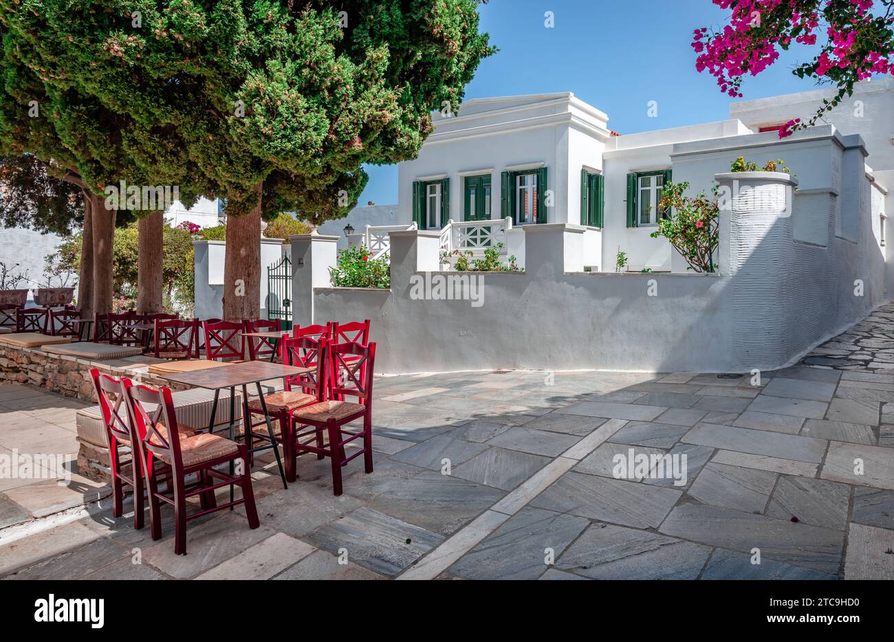 Sidewalk cafe with tables under the shadow of the trees in the ...