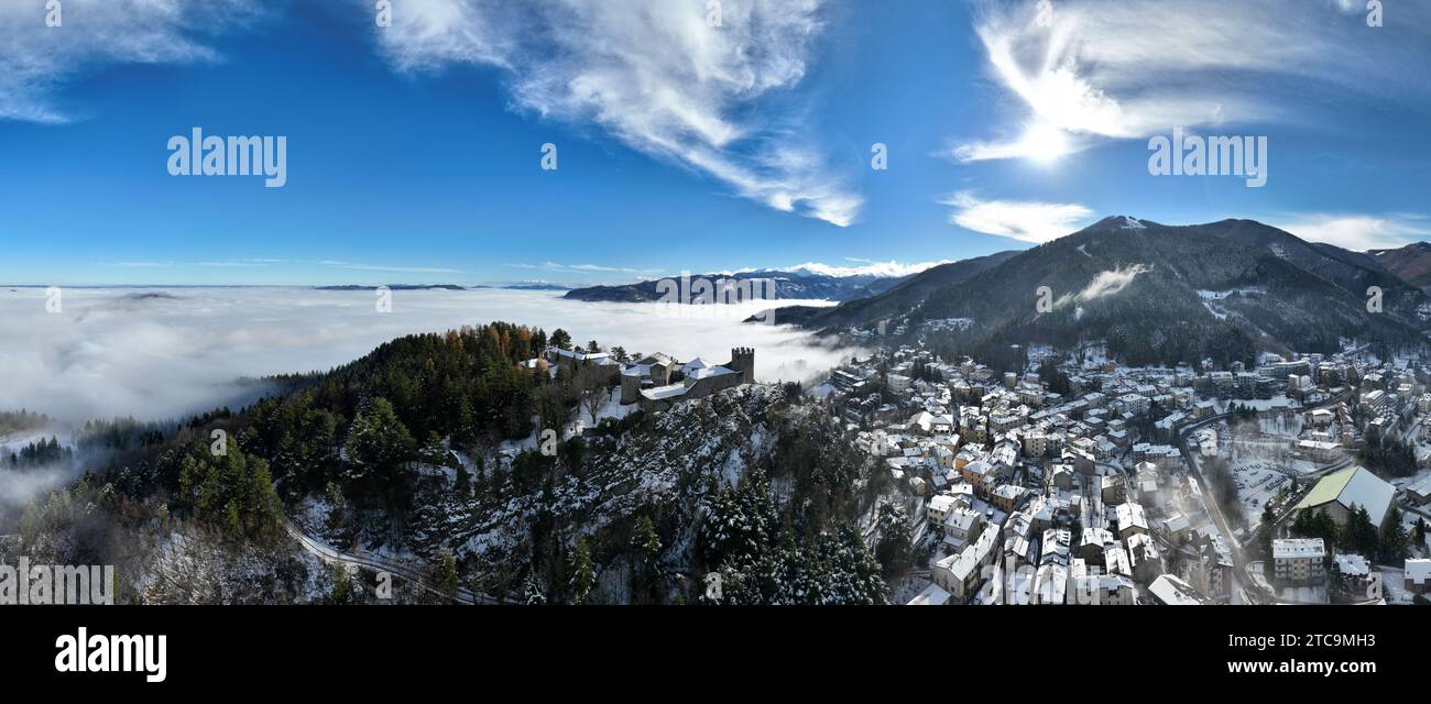 A rural mountain town is illuminated by the soft light of the setting ...