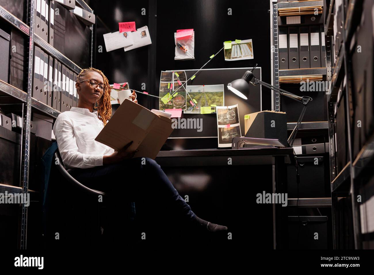 Woman police investigator studying csi expertise report in office ...