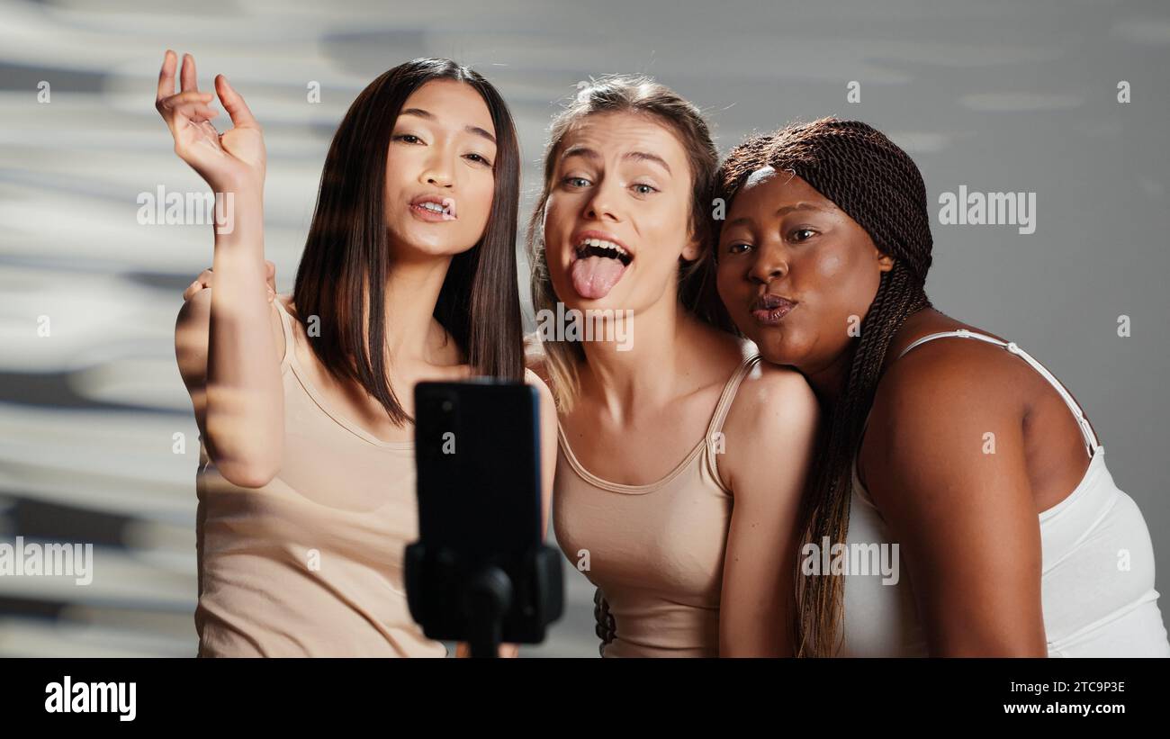 Interracial Group Of Friends Taking Photos On Smartphone To Promote