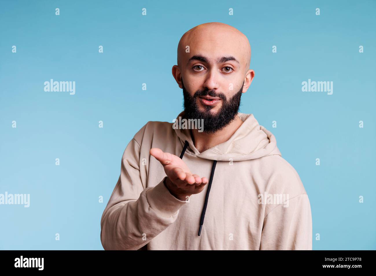 Arab man blowing air kiss with charming smile and looking at camera ...