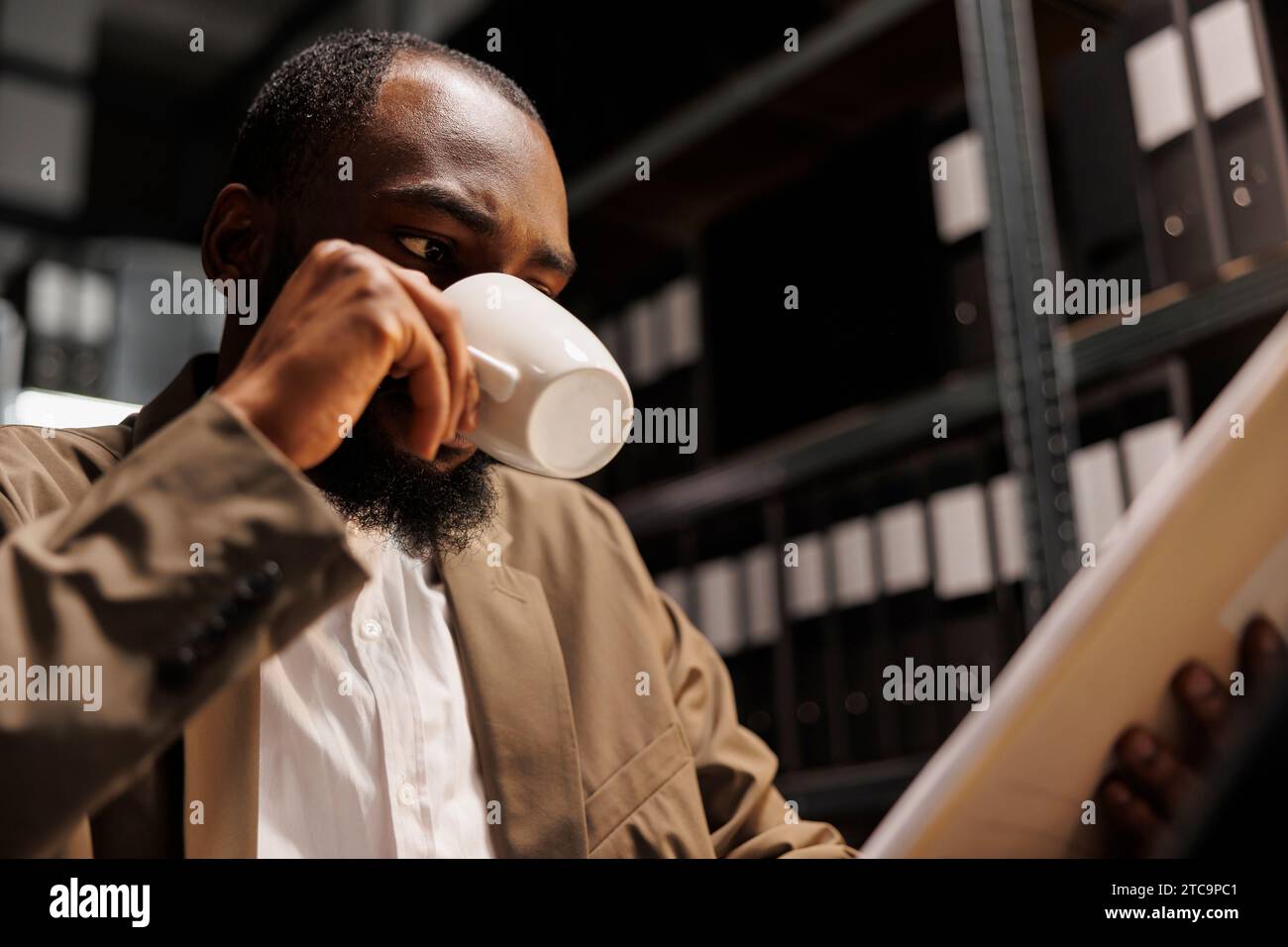 Private investigator drinking coffee while examining police ...