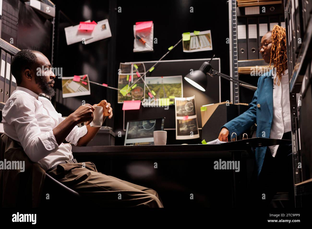 Detectives team conducting crime case investigation together, drinking ...