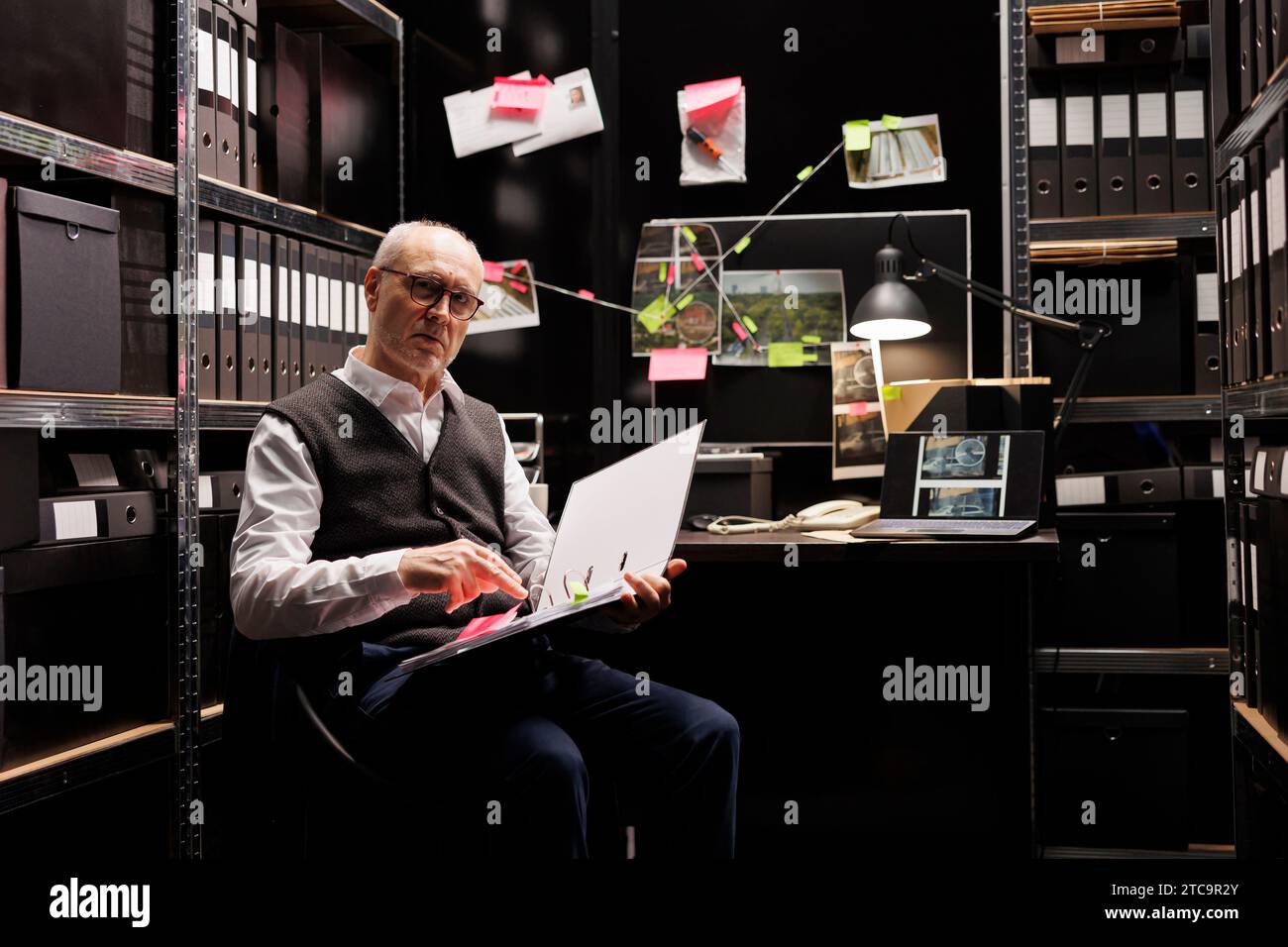 Elderly criminal investigator analyzing crime scene report, checking ...