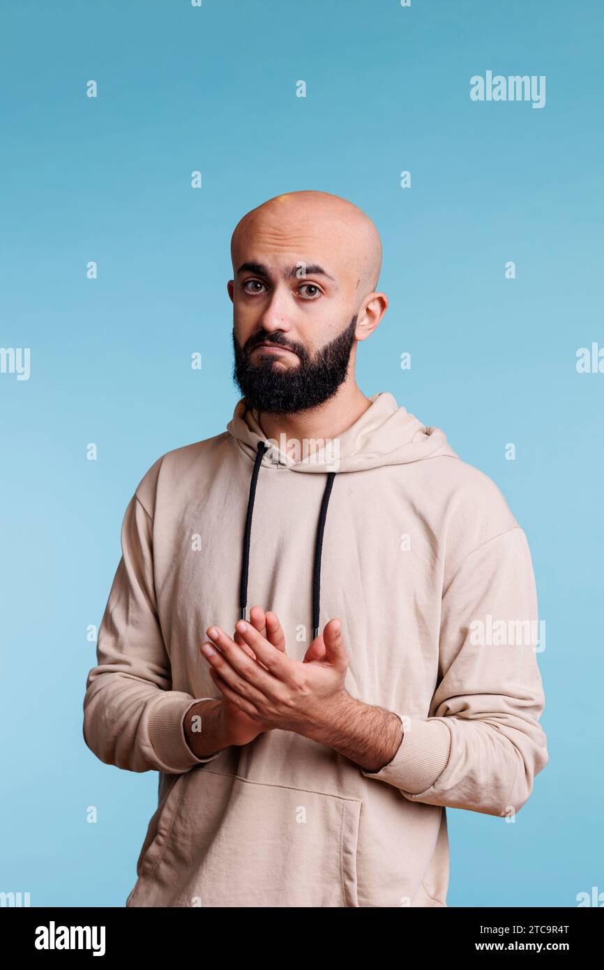 Arab man clapping hands and looking at camera with respect facial ...