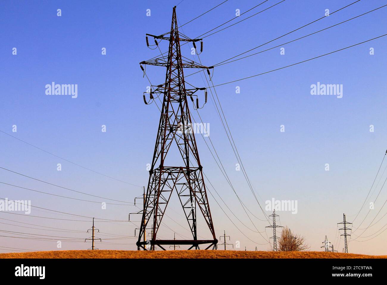 High voltage electricity line in Ukraine On Sunset. Concept of Russian ...